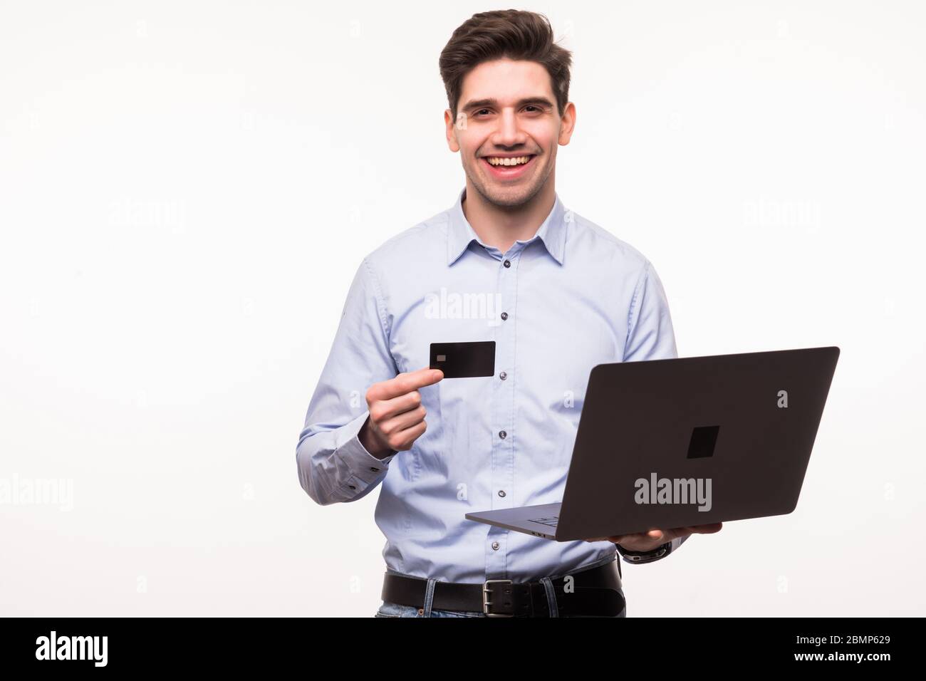 business man holding a credit card and laptop on white background Stock ...
