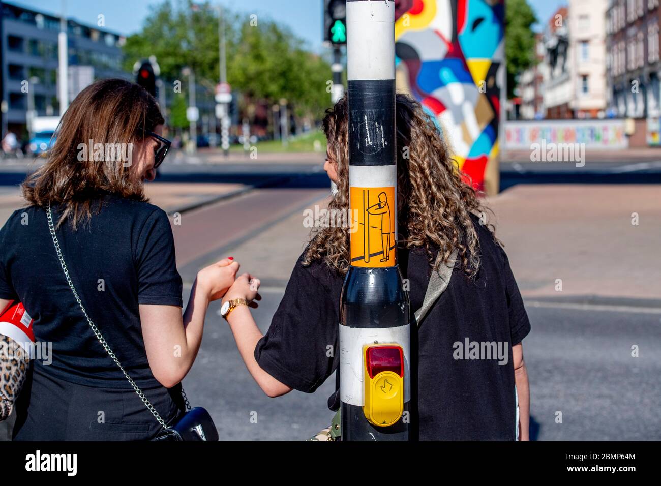 A view of an elbow use sticker at the traffic lights during the ...