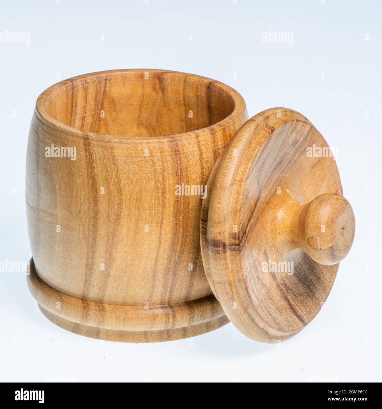Small wooden barrel-shaped container with open lid, square image on ...