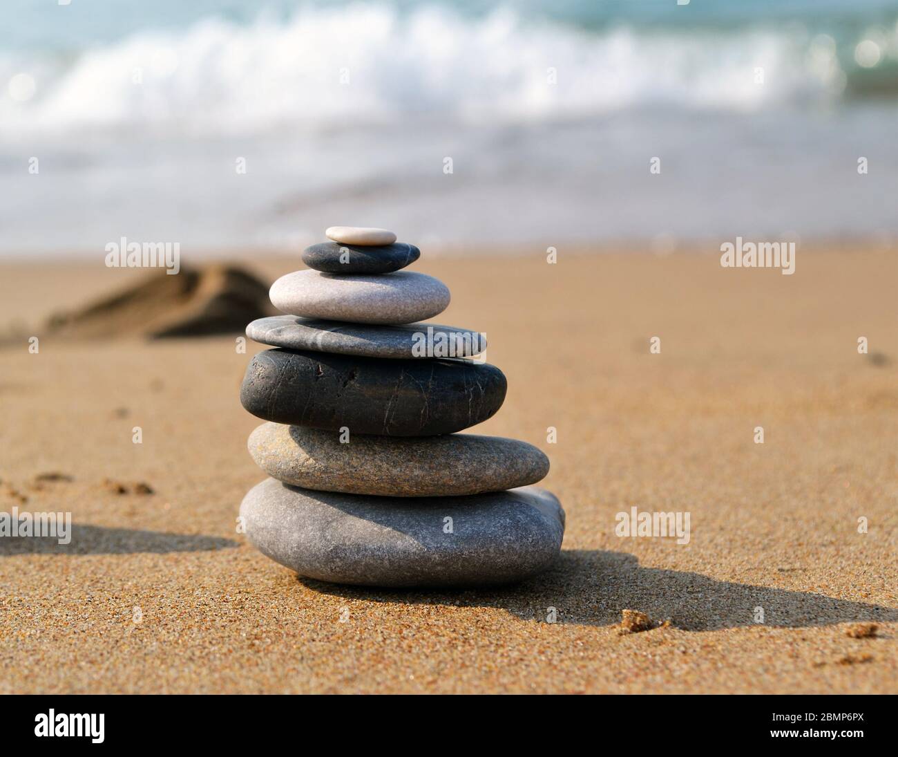 Small Zen style tower made of different sizes and color stones ...