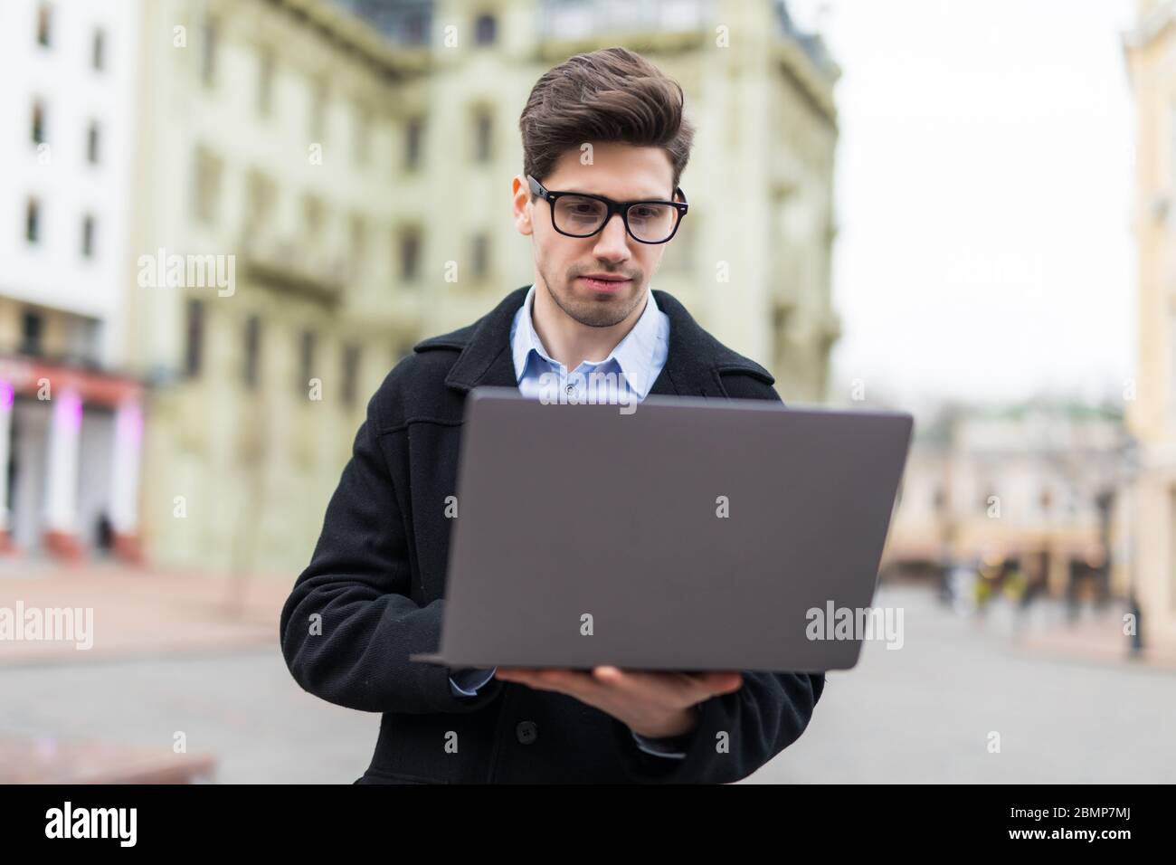 portrait of male college student use laptop at campus Stock Photo - Alamy