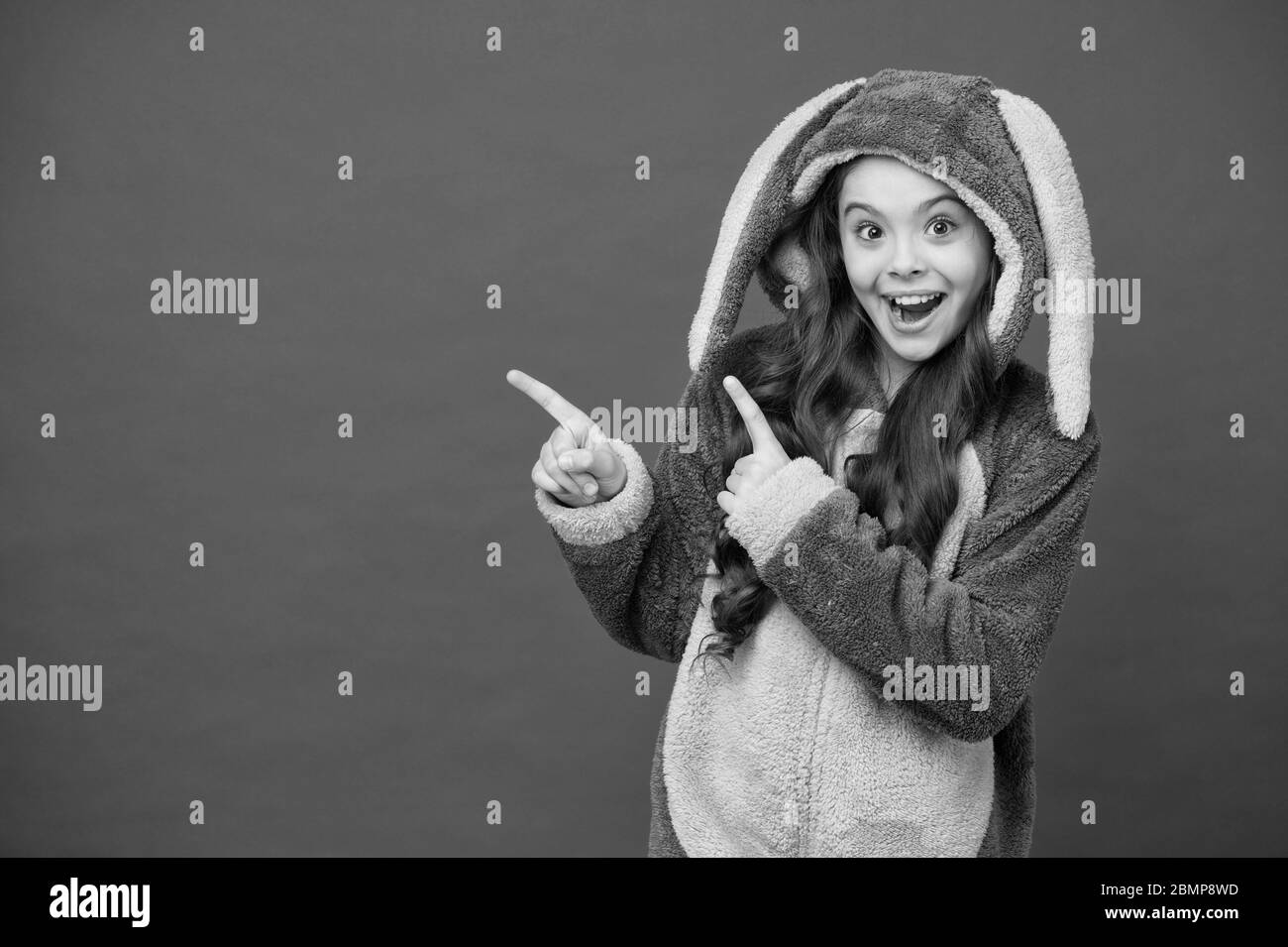 Take a look. Happy girl pointing index fingers at something. Small ...