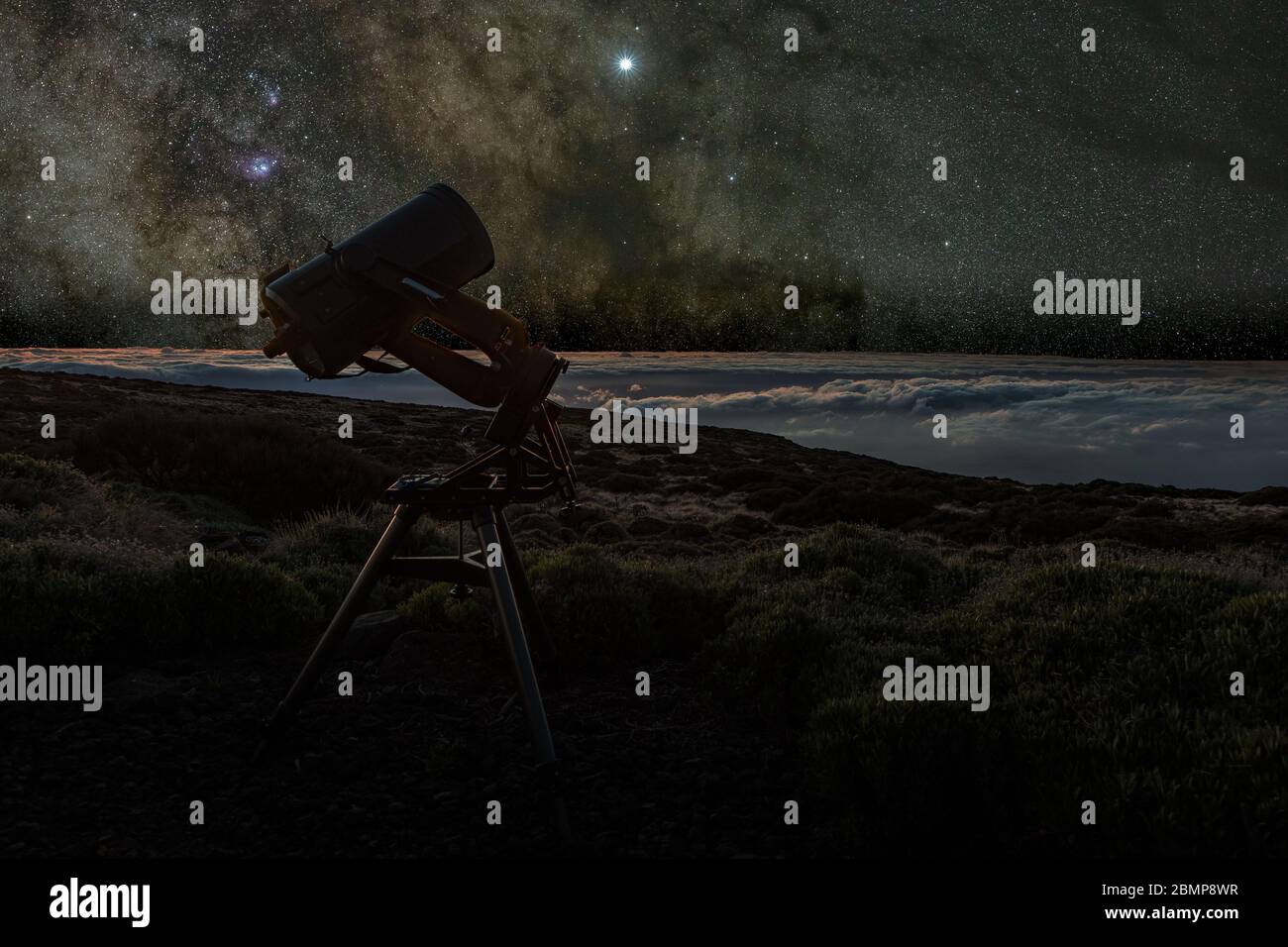 Night sky above the silver clouds. Telescope watching the Milky Way in ...