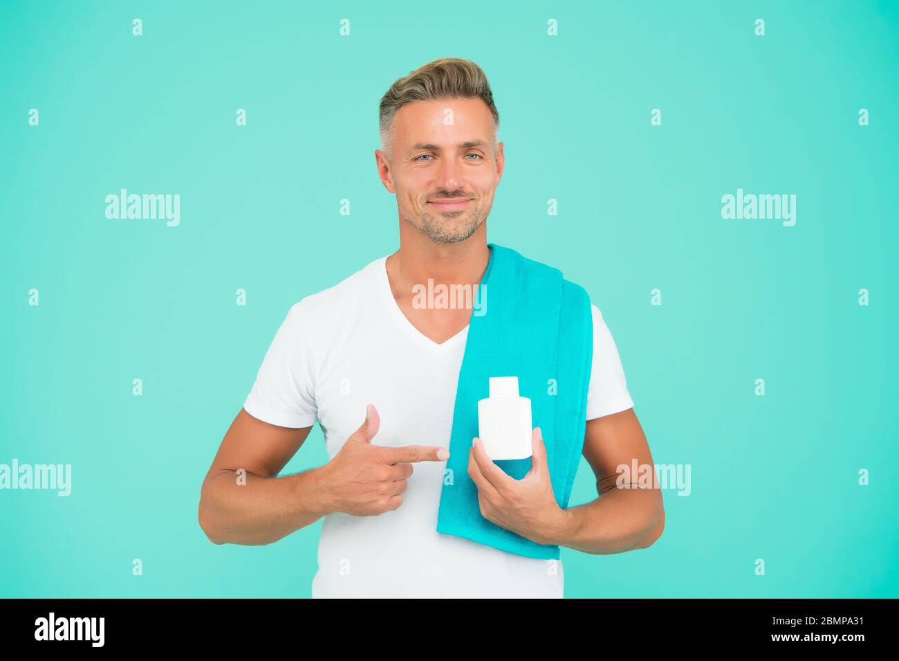 handsome man with pill jar. guy presenting gel bottle. male beauty and ...