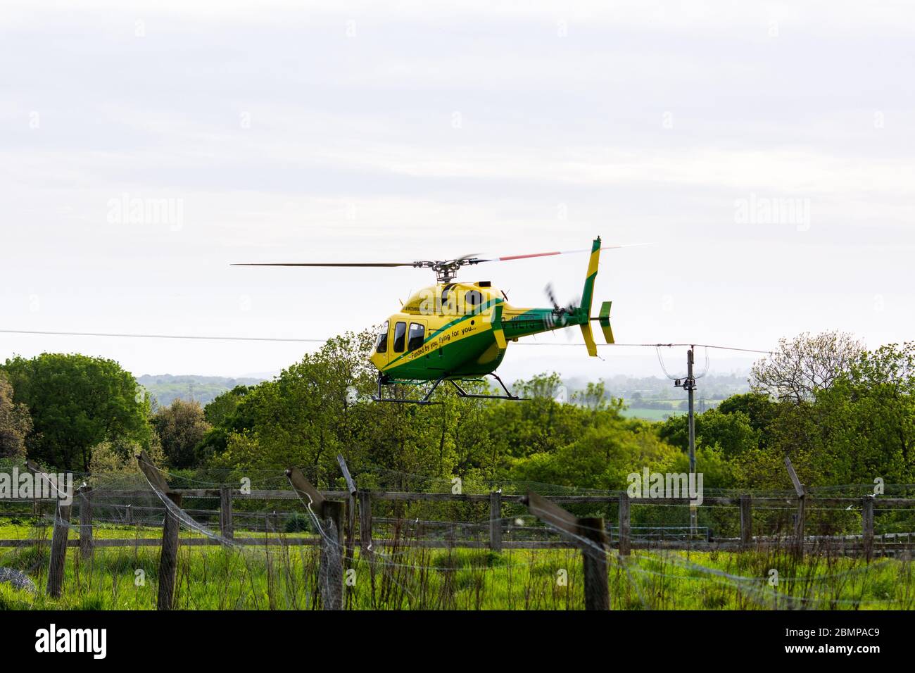 The green and yellow Bell 429 helicopter reg G-WLTS of the Wiltshire ...