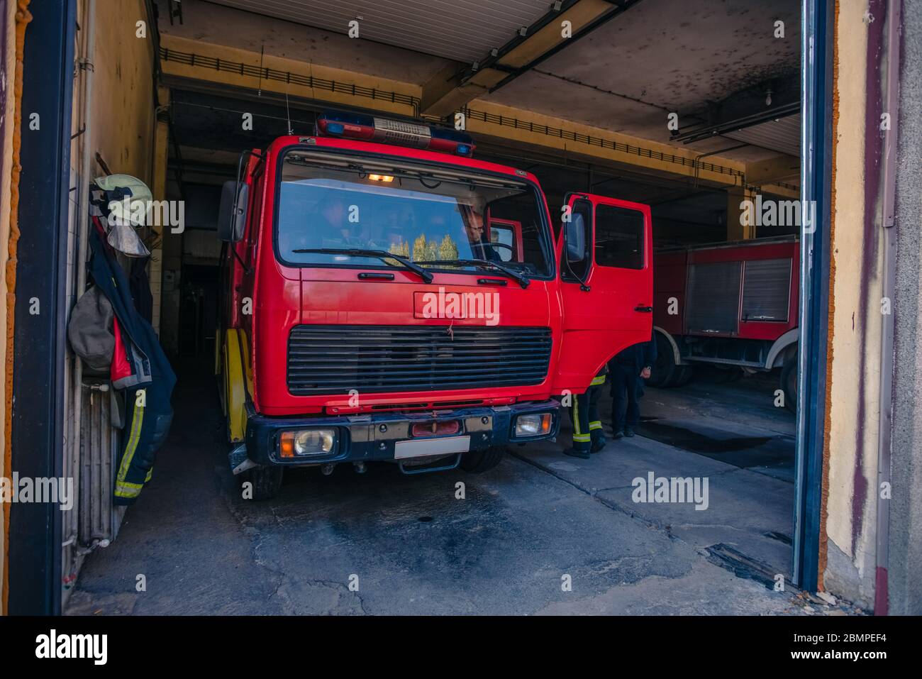 Fire engine inside the garage of the fire department Stock Photo - Alamy