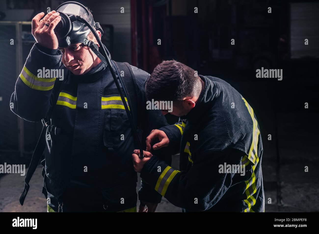 Firefighters with protective uniform wearing oxygen mask Stock Photo ...