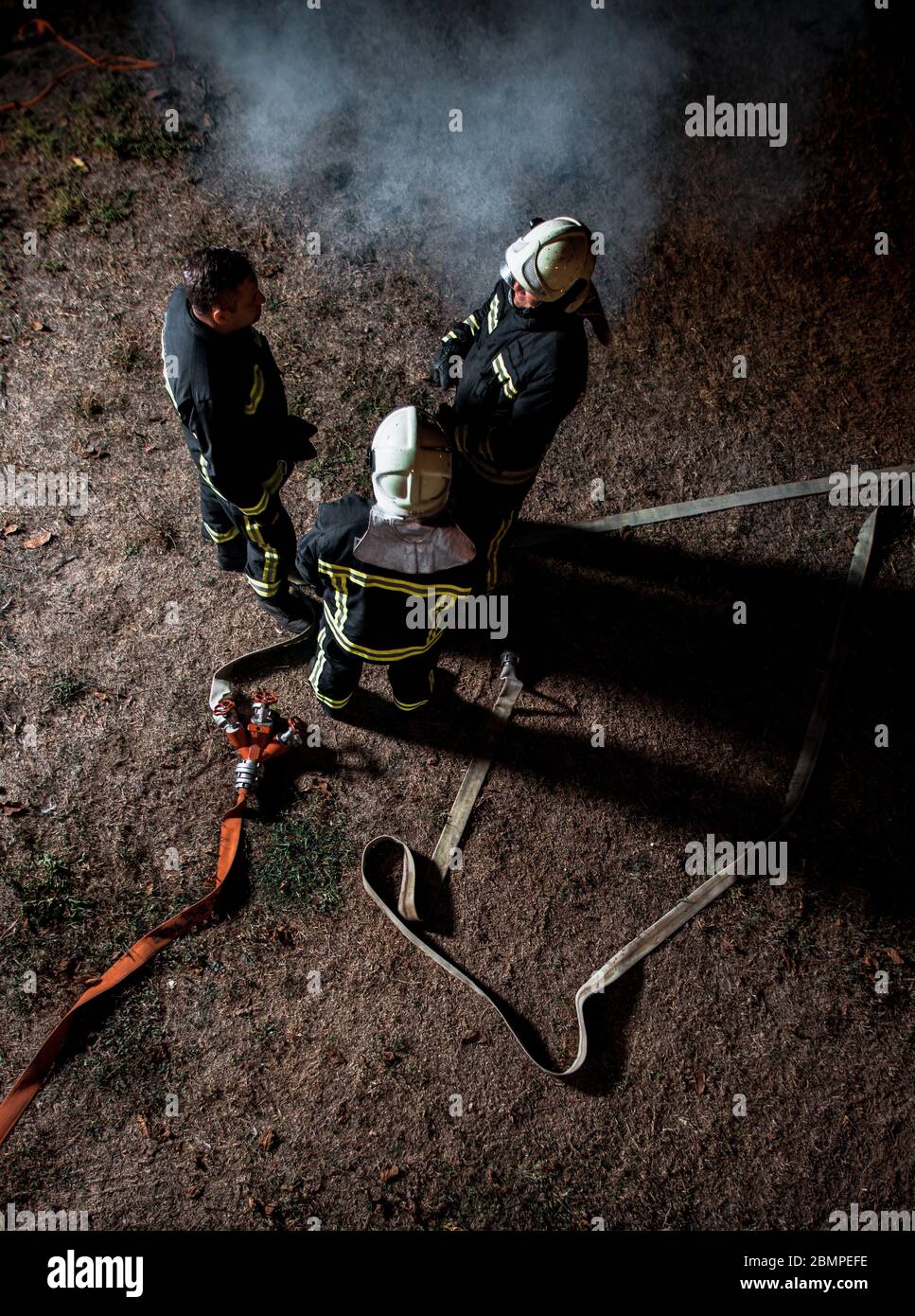 Fire brigade fighting a forest fire with various tools for eliminating ...