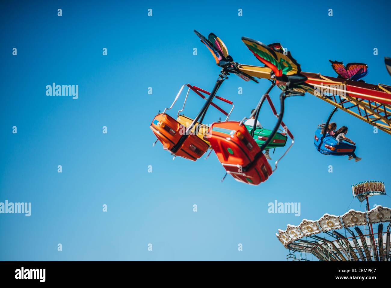 Young people having great time riding the swinging carousel ride Stock ...