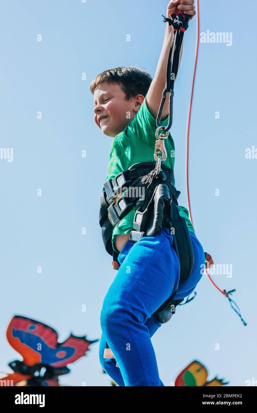 Boy on a bungee trampoline hi-res stock photography and images - Alamy