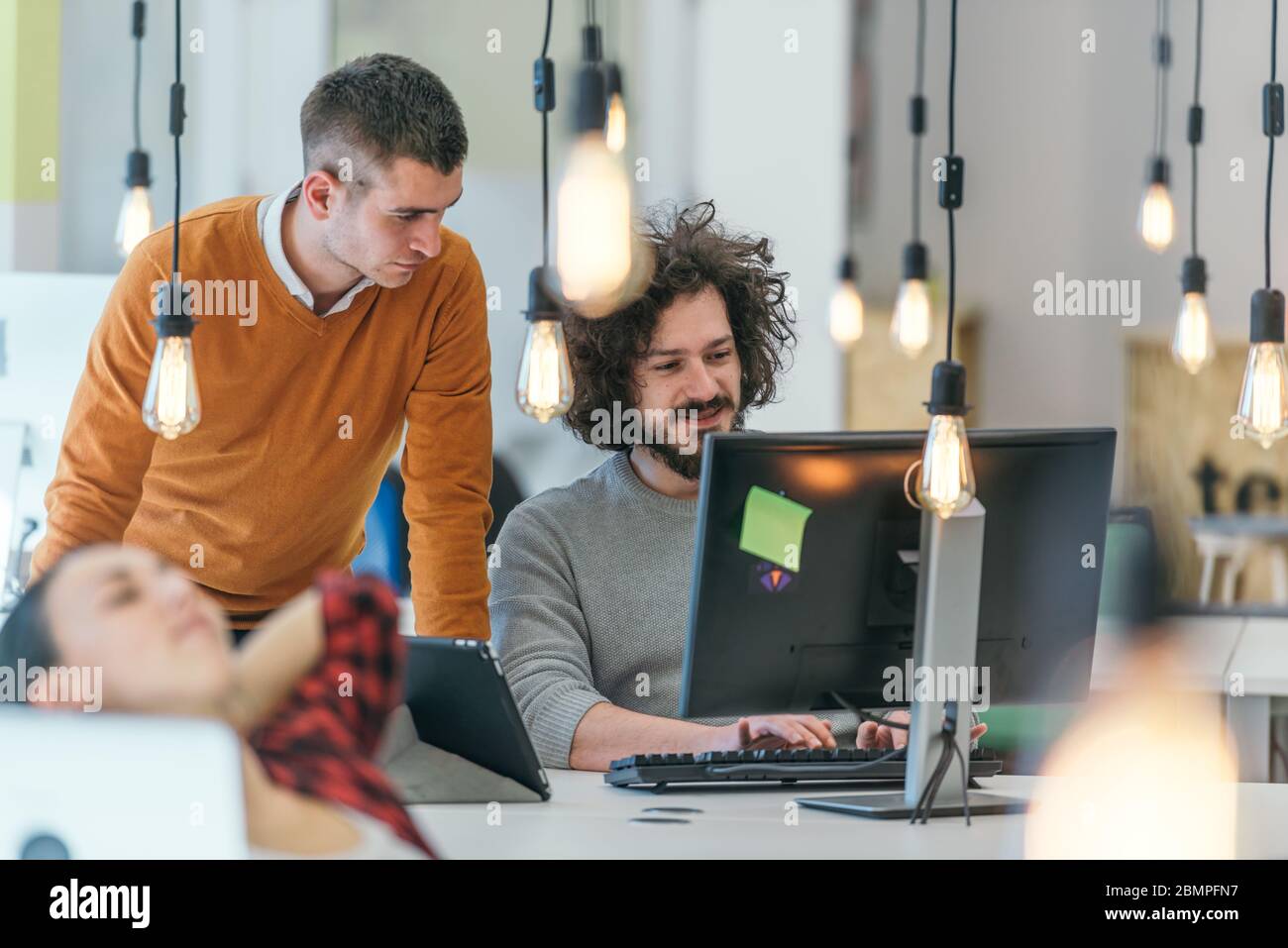 Portrait of two busy colleagues working on pc economy project on modern ...