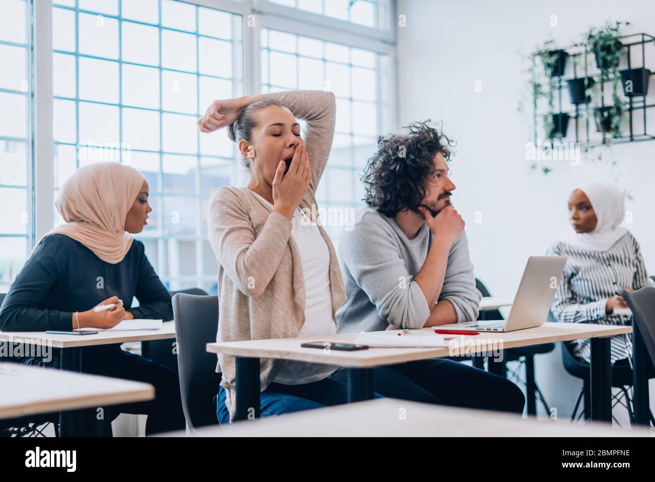 Group of work colleagues talking about the business plan at the office ...