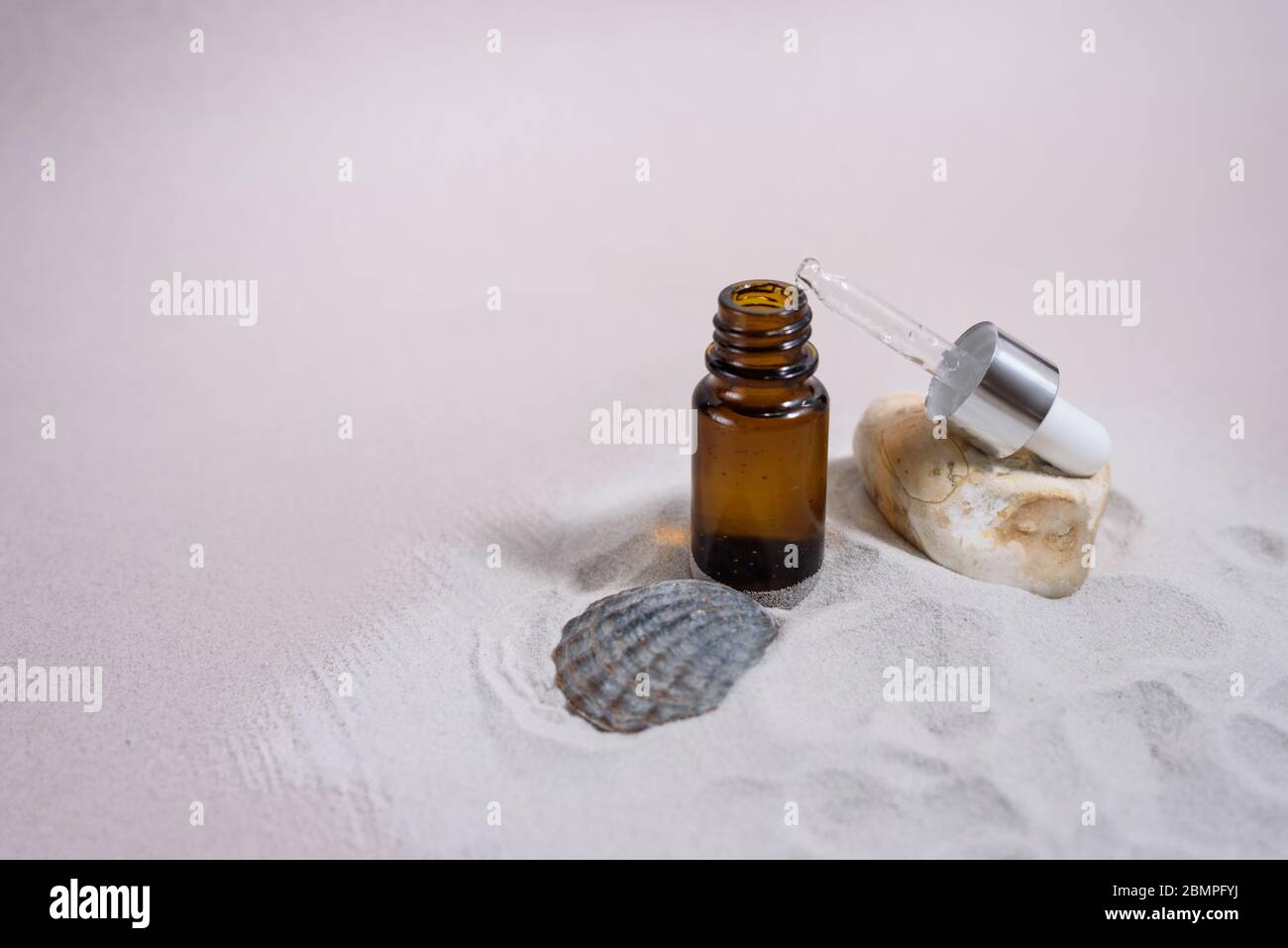 A glass dropper bottle with a pippette with white rubber tip on the ...