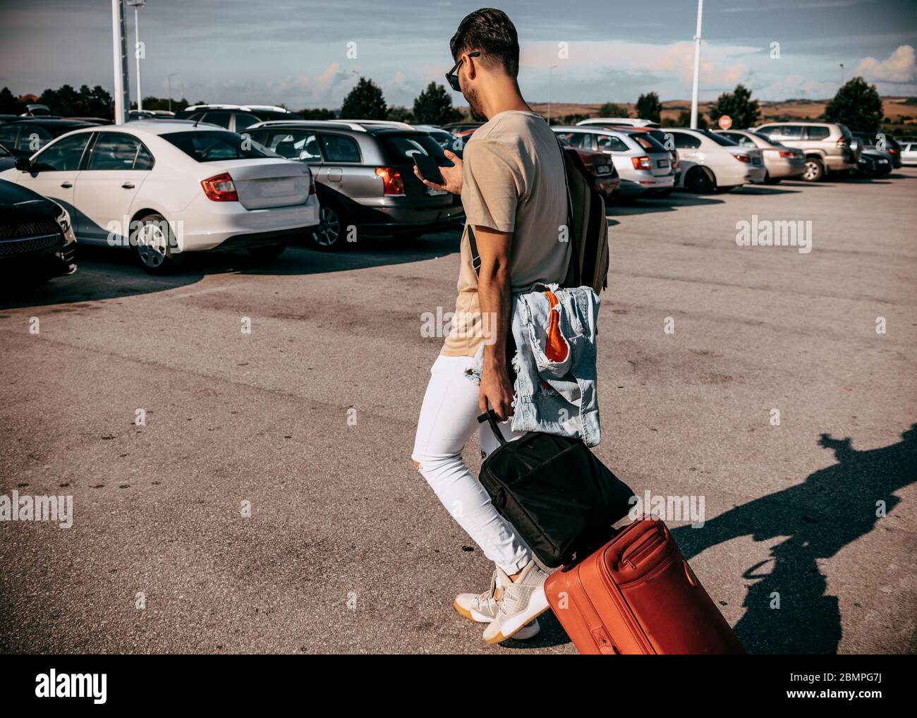 Man carries luggage or trolley while taking off his plane Stock Photo ...