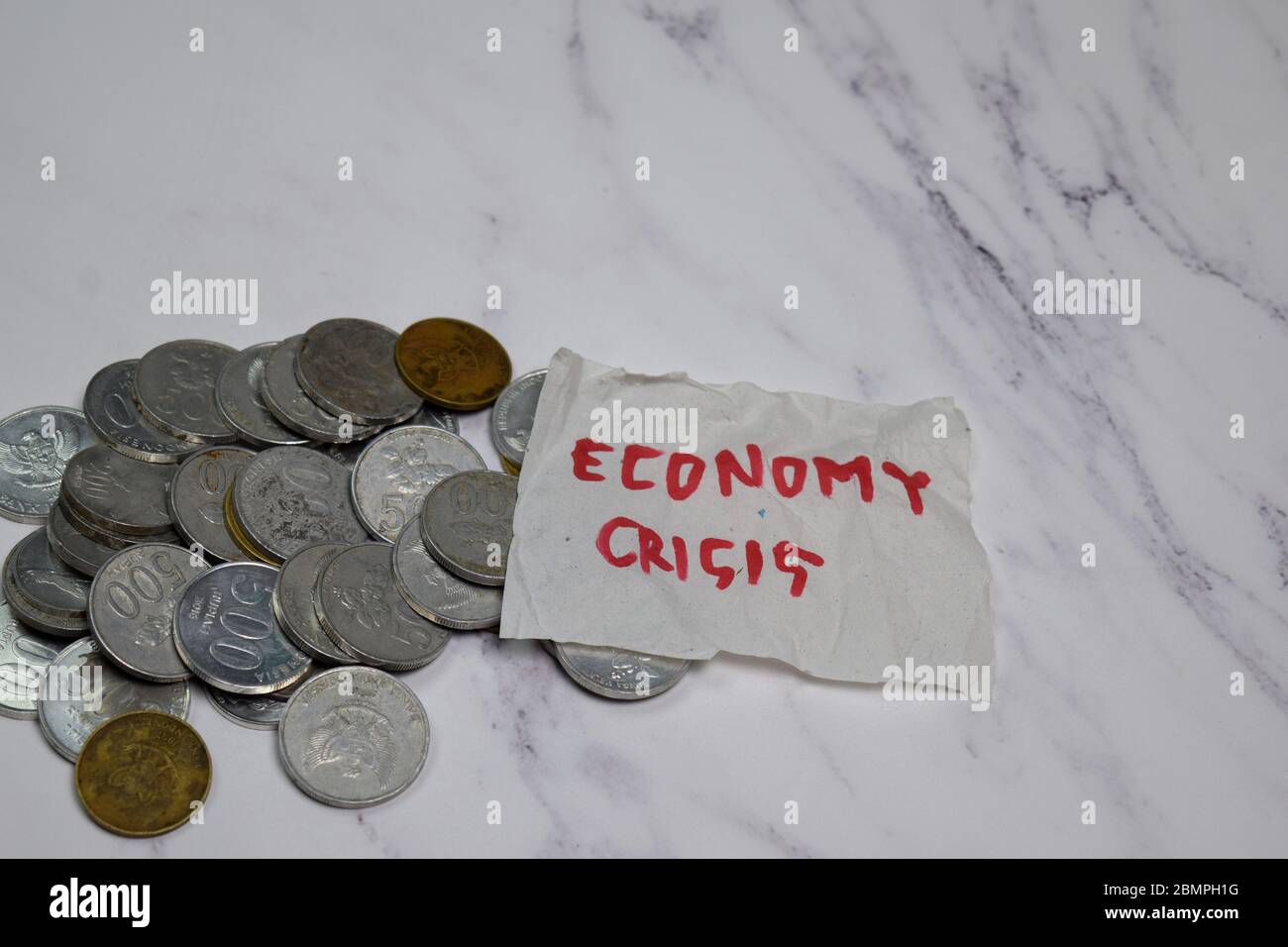 Economy Crisis write on sticky notes and coins isolated on office desk ...