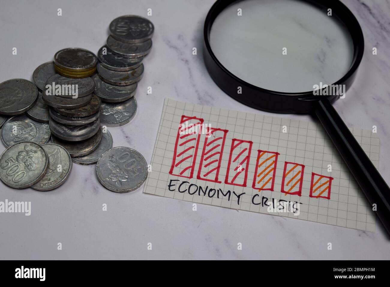 Economy Crisis and coins write on sticky notes isolated on office desk ...