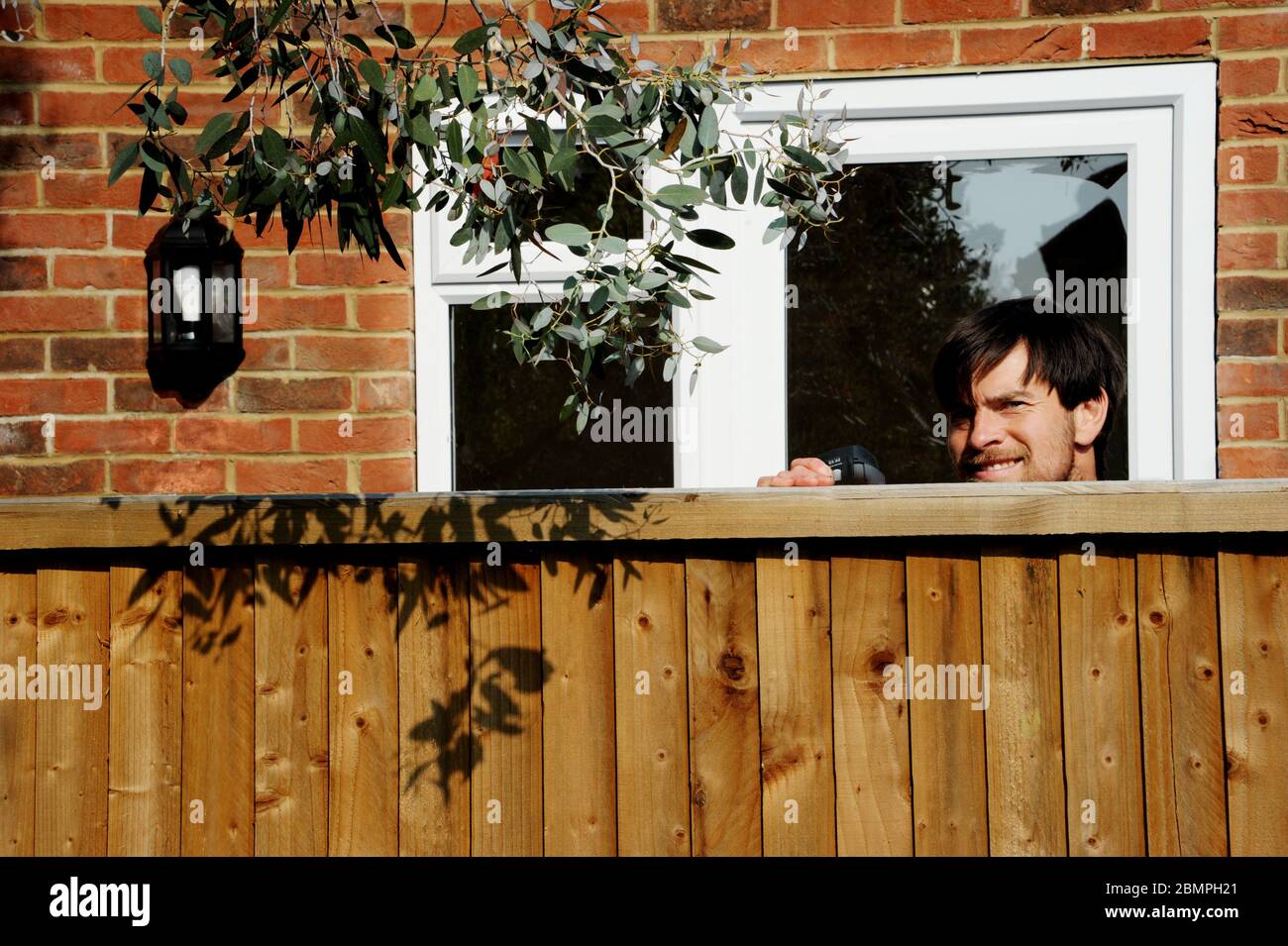 Nosy neighbour fence hi-res stock photography and images - Alamy
