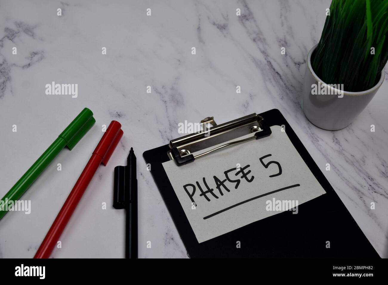 Phase 5 write on clipboard isolated on office desk Stock Photo - Alamy