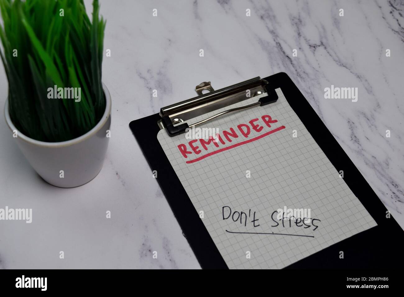 Reminder and Don't Stress write on clipboard isolated on office desk ...