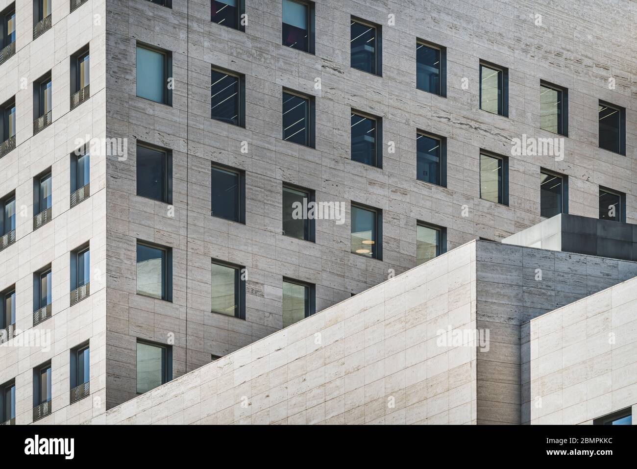 Geometric view of a modern business building built in roman travertine ...
