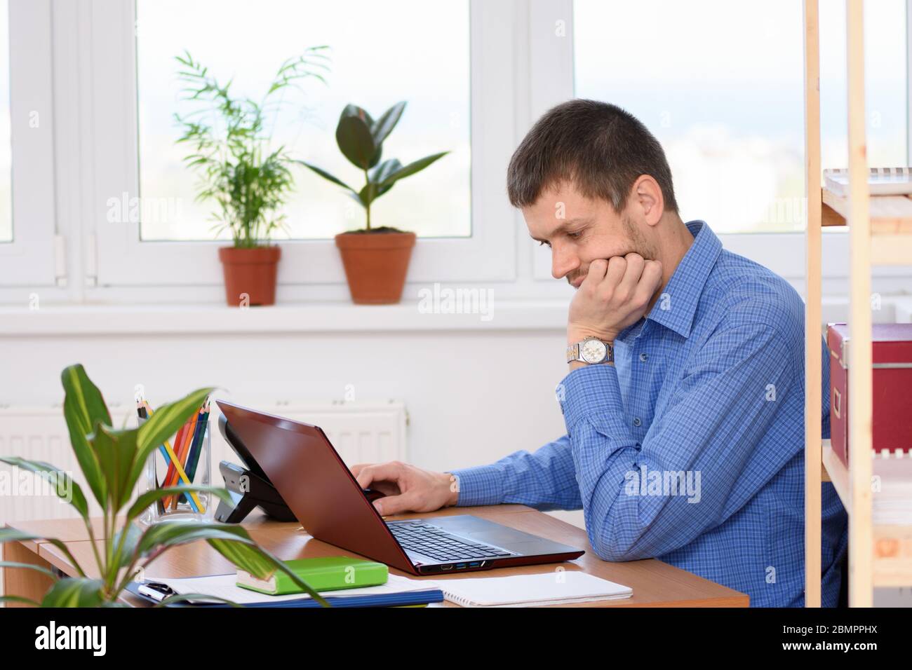 Office specialist working in a laptop at his workplace Stock Photo - Alamy