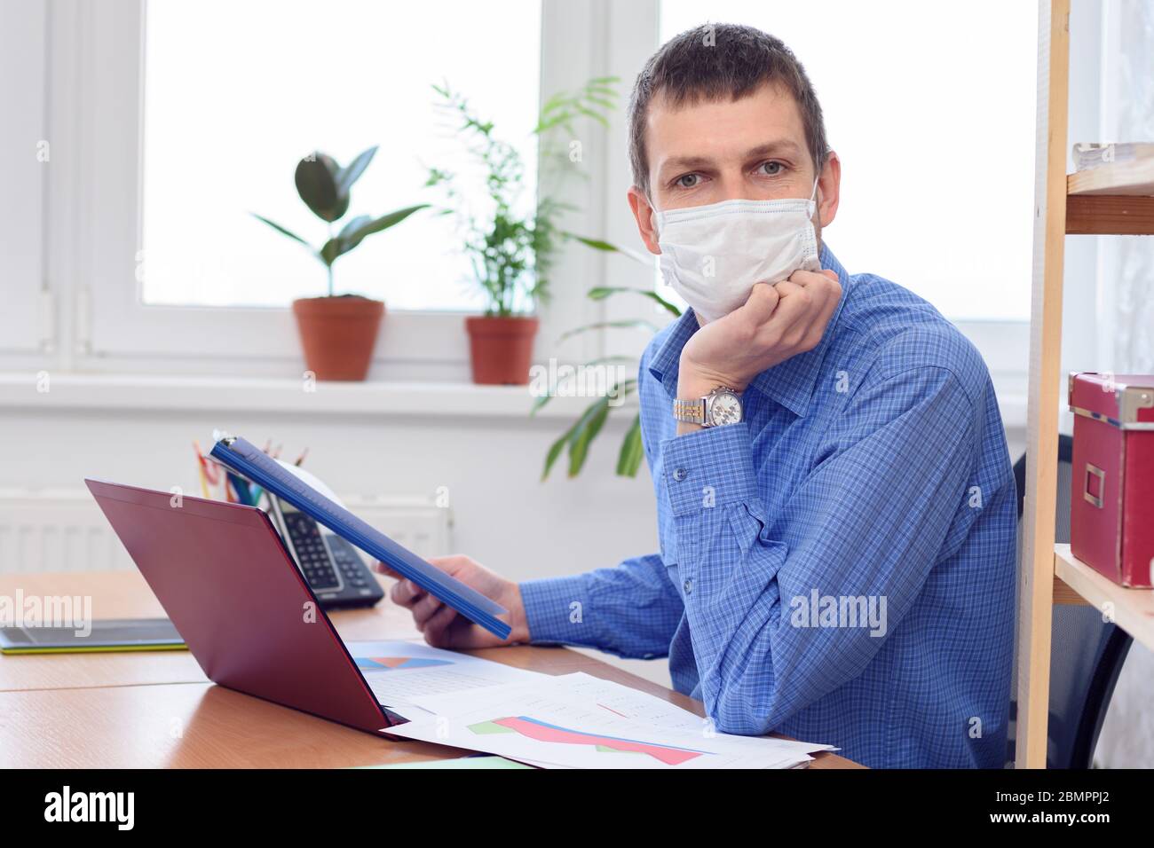 Office specialist in a medical mask at work Stock Photo - Alamy