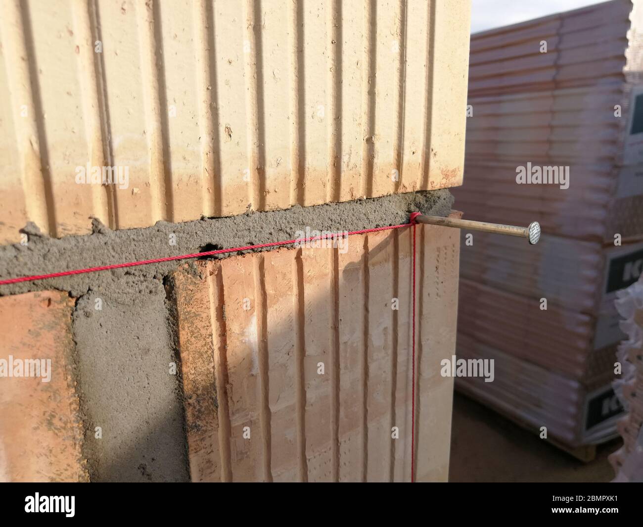 Nail and string for ceramic building block construction leveling in ...