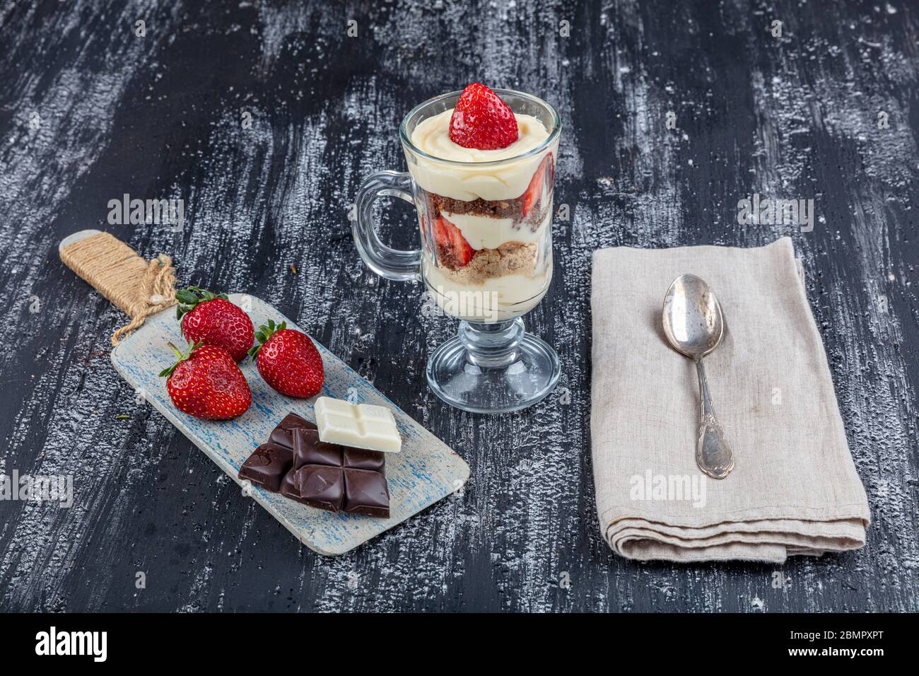 Magnolia Dessert. Strawberry magnolia dessert in glass cup on wooden ...