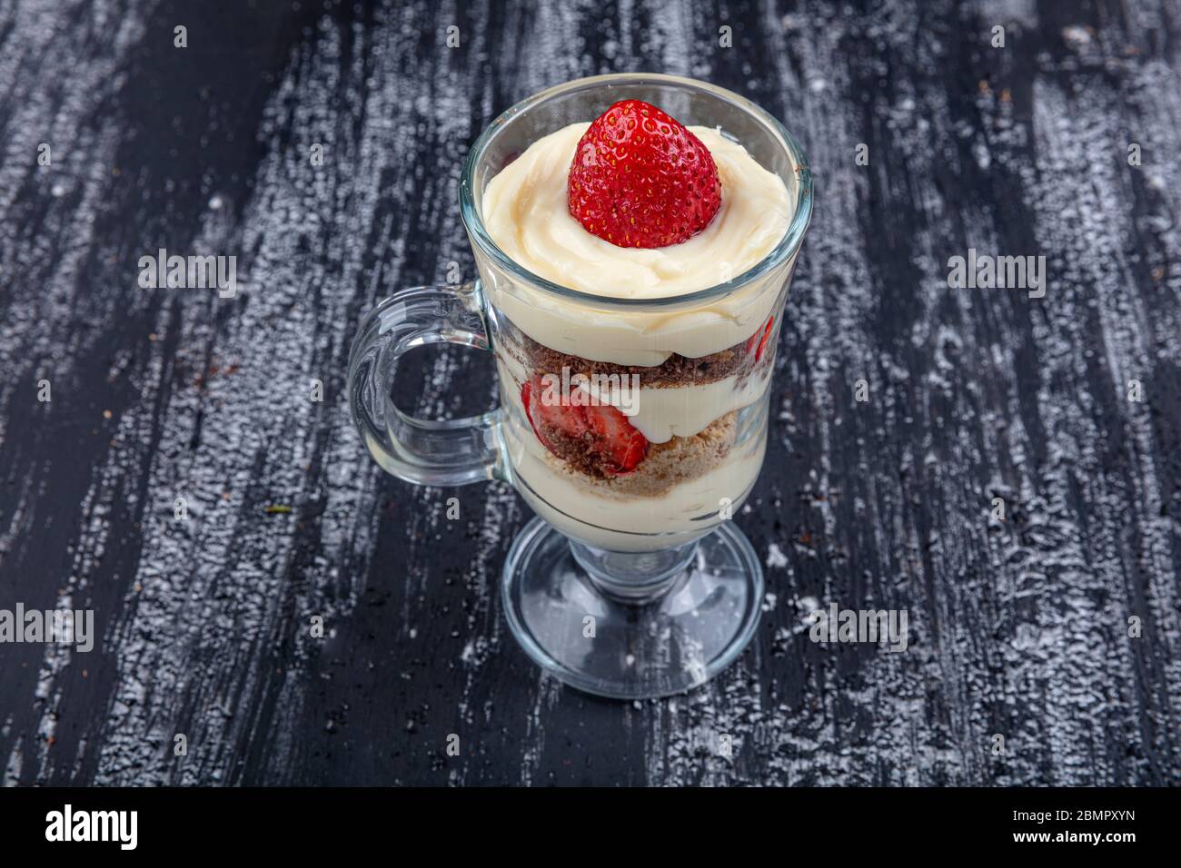 Magnolia Dessert. Strawberry magnolia dessert in glass cup on wooden ...