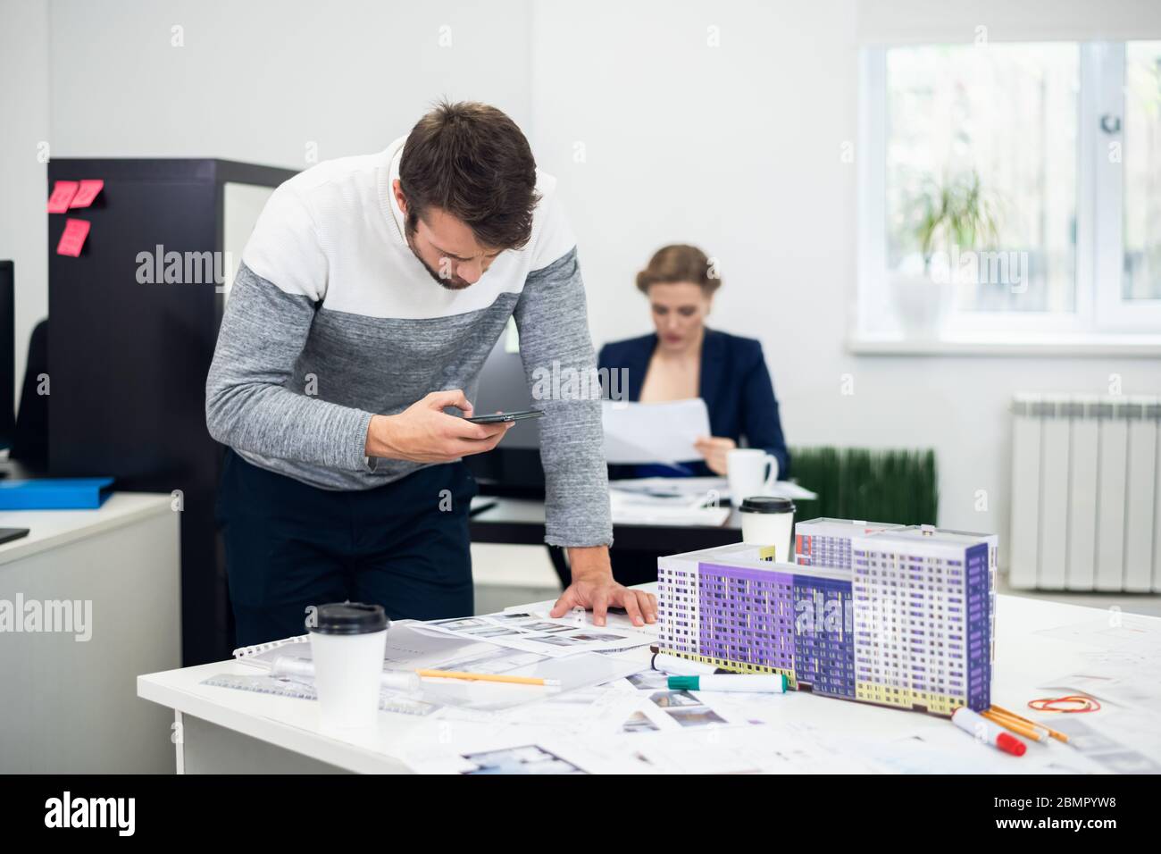 A young architect taking pictures of his construction project wh Stock ...