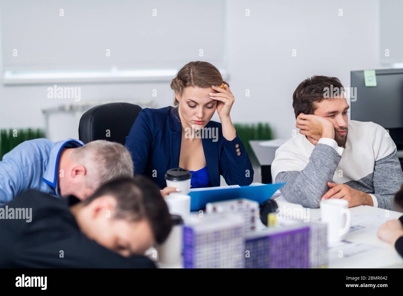 Business people resting in the conference room during a meeting, while ...