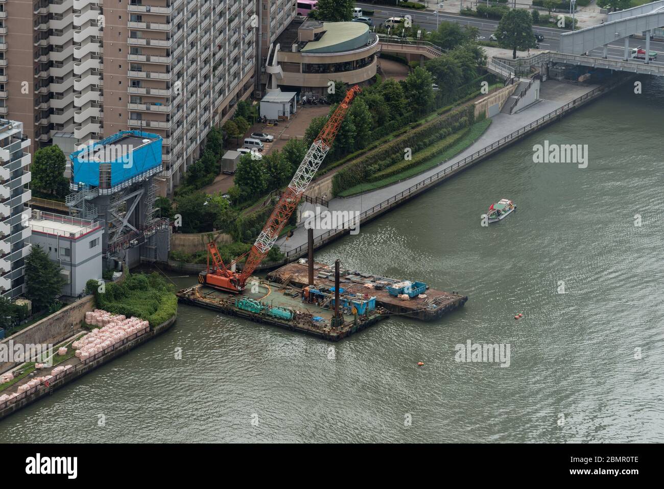 Lifting crane on a platform on river bank in Tokyo Chuo district in ...
