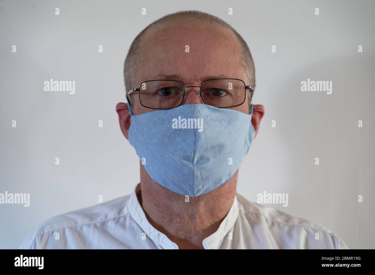 A mask is worn by a male to help prevent the spread of the corona virus ...