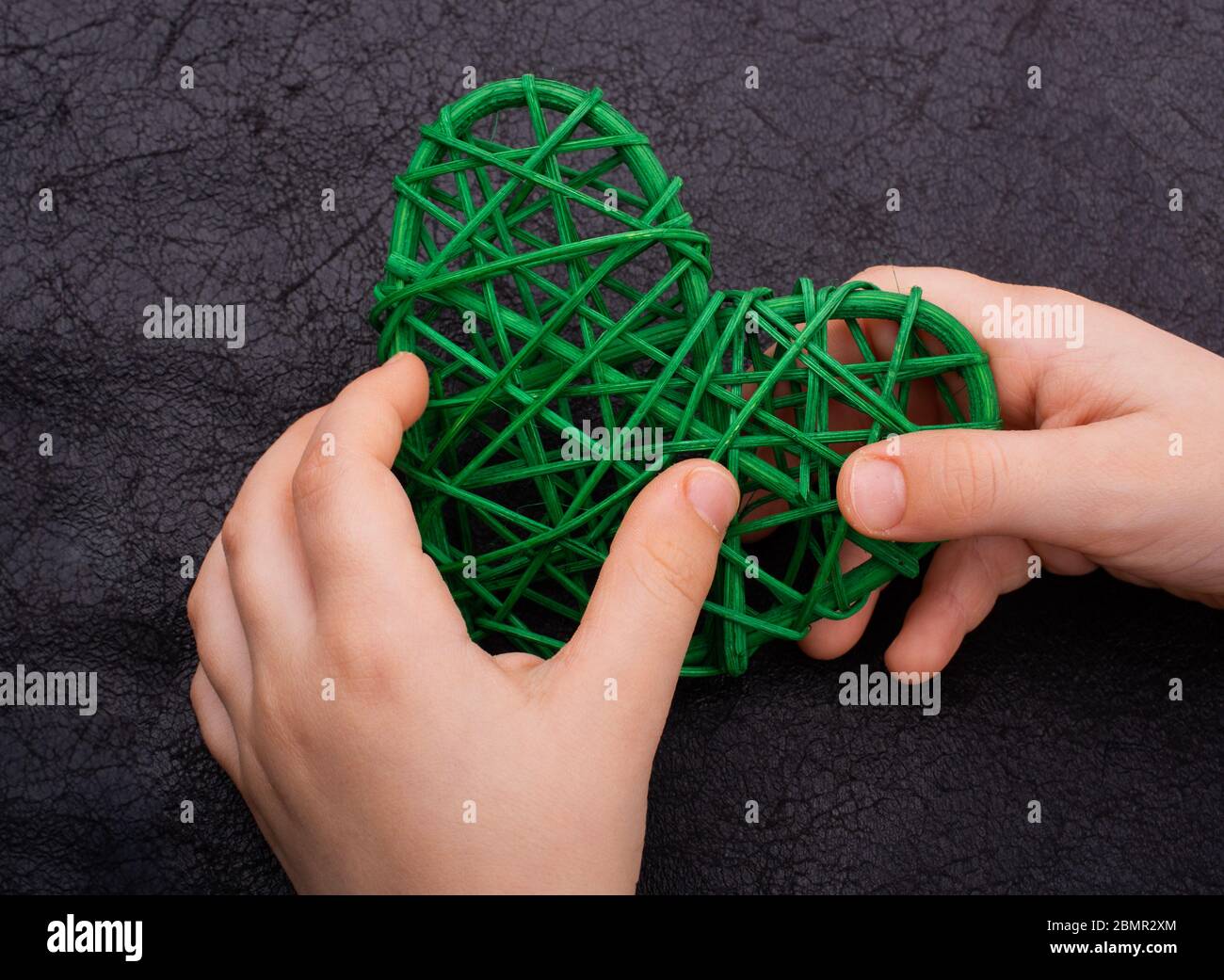 Handmade straw heart or valentines day object in hand Stock Photo - Alamy