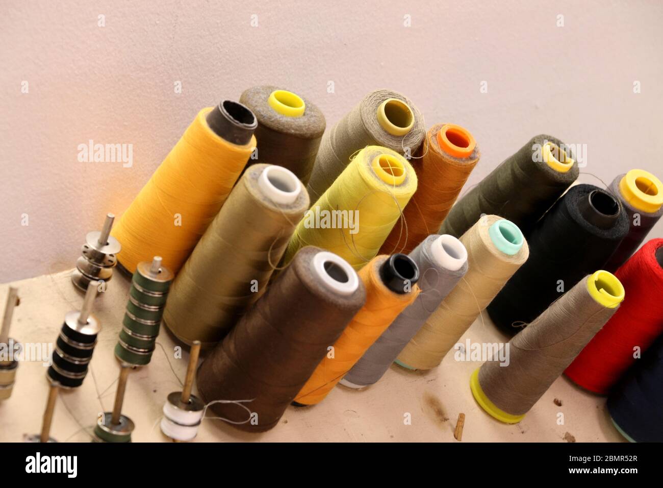 Spindles of brightly colored threads in a seamstress' work room Stock ...