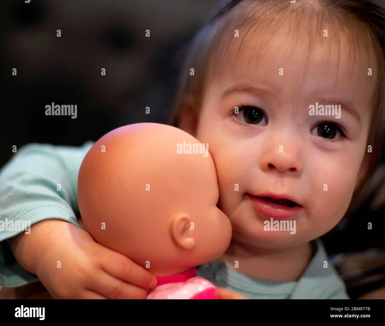 Young child with her doll Stock Photo - Alamy