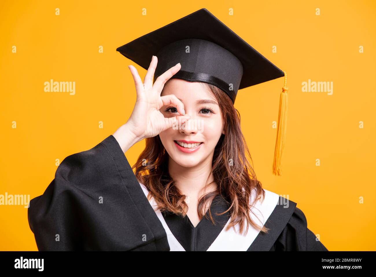 happy young woman in graduation gowns with looking gesture Stock Photo ...