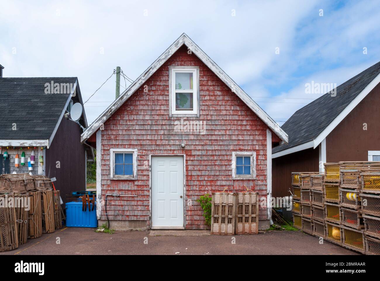 Quaint fisherman's shack by the docks. Weathered red-painted shingle ...