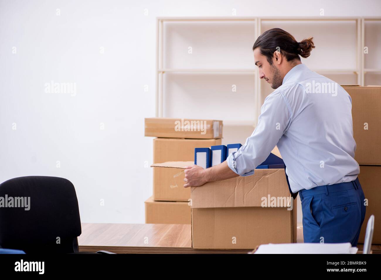 Young employee in relocation concept Stock Photo - Alamy