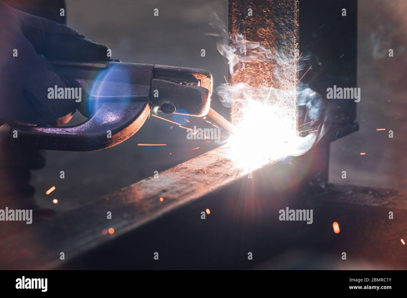 Close-up of the welding process of two metal parts. Industrial ...
