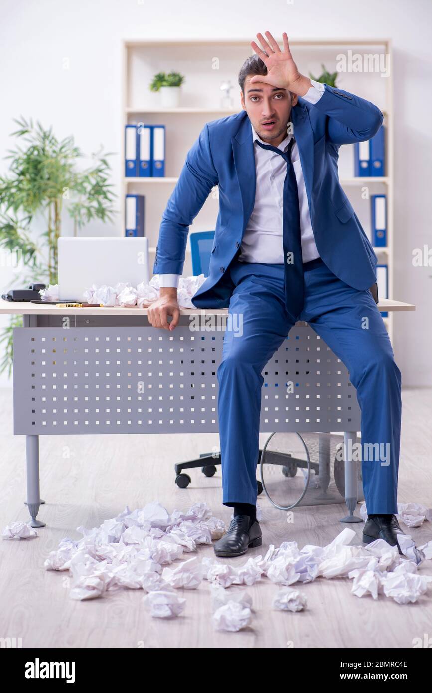 Businessman rejecting ideas with lots of papers Stock Photo - Alamy