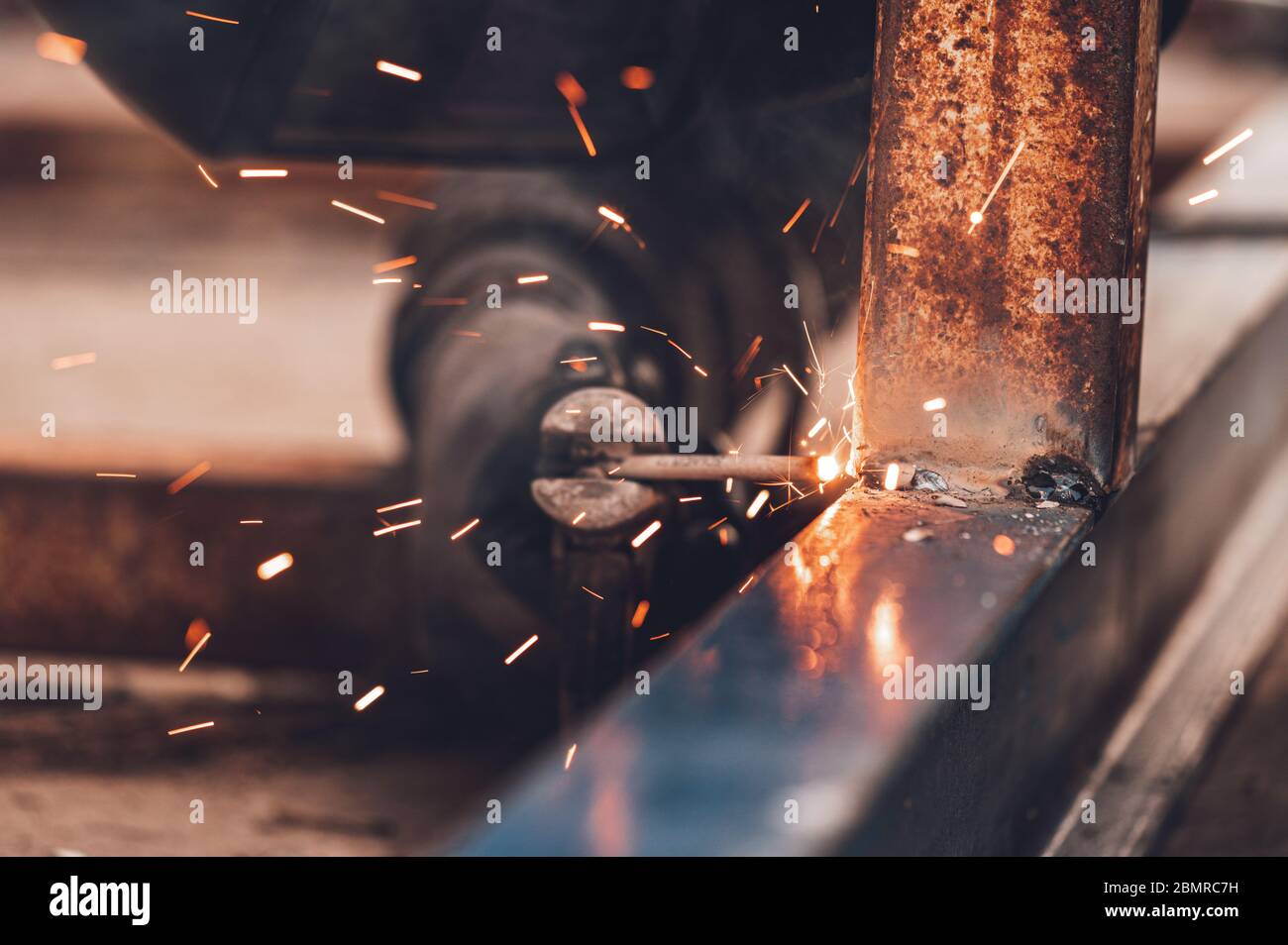 Close-up of the welding process of two metal parts. Industrial ...