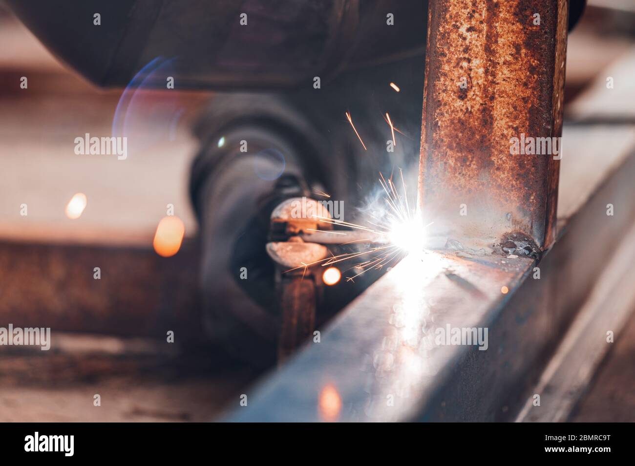 Close-up of the welding process of two metal parts. Industrial ...