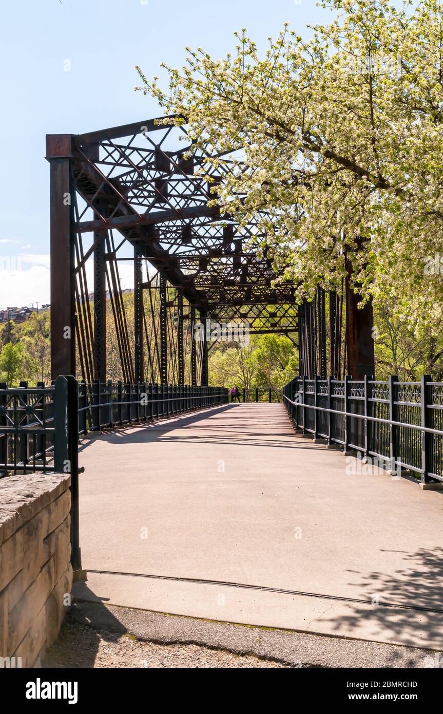 An old railroad bridge converted into a walking trail on a sunny spring ...