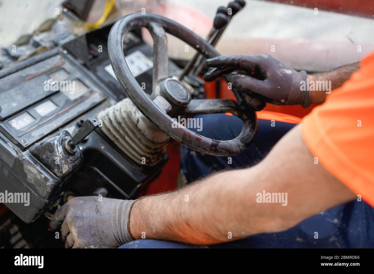 Construction worker starting the excavator machine Stock Photo - Alamy