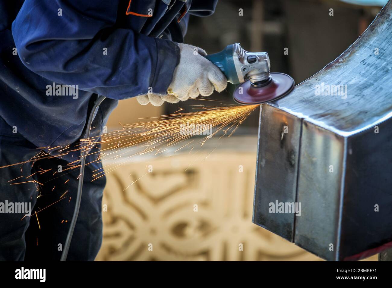 Master grind metal a grinder sparks Stock Photo - Alamy