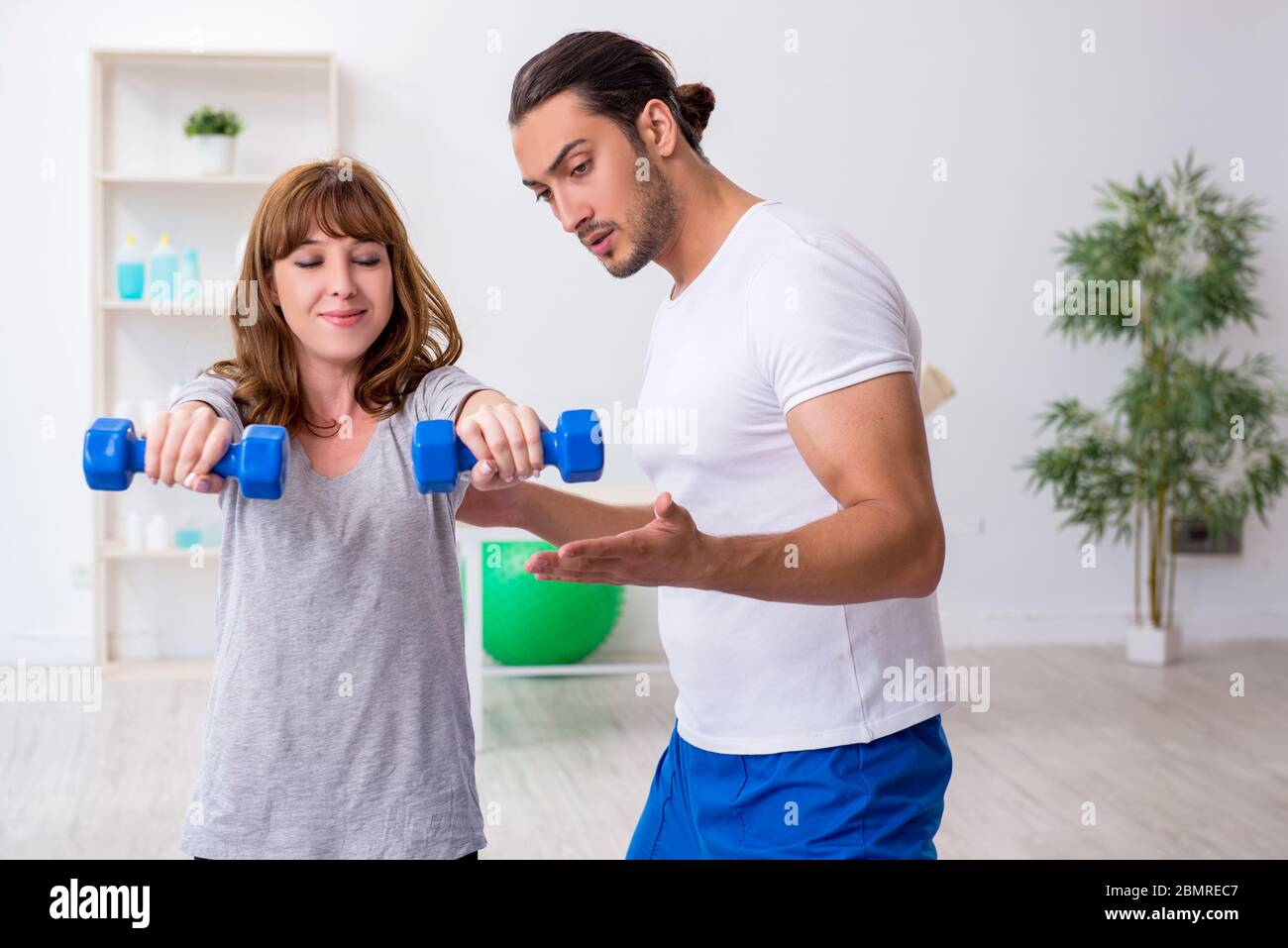 Young coach showing exercises hi-res stock photography and images - Alamy