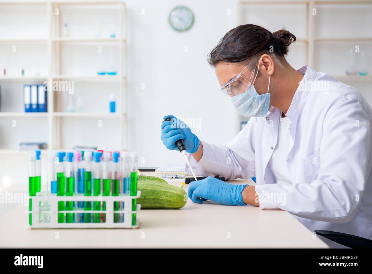 The male nutrition expert testing vegetables in lab Stock Photo - Alamy