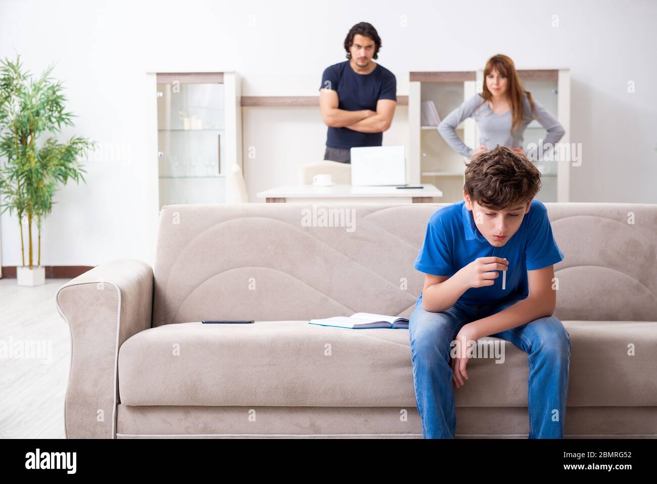 The concept of underage smoking with young boy and family Stock Photo ...