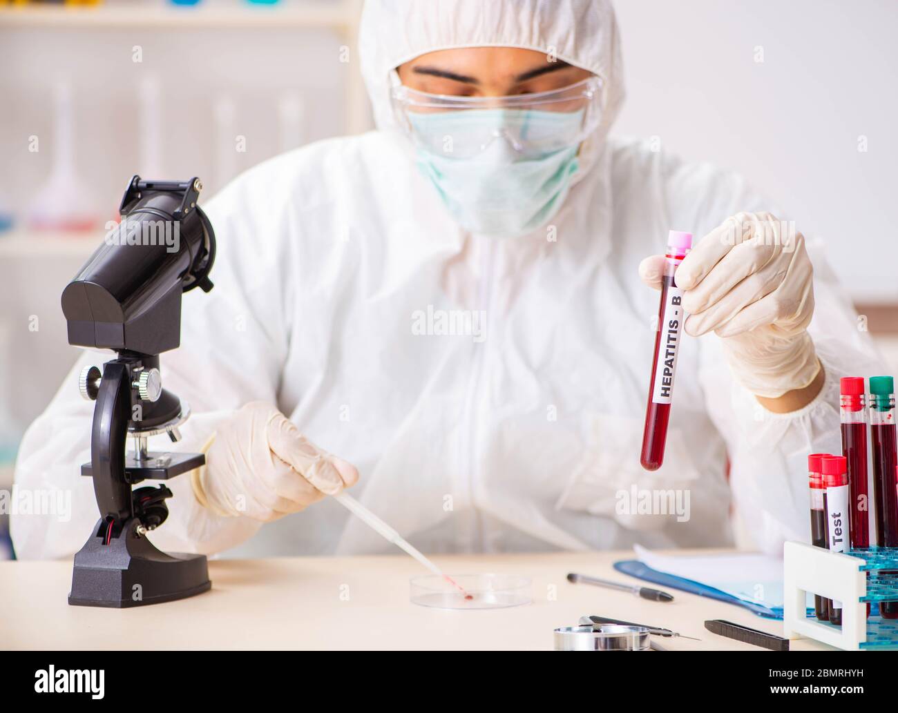 The young handsome lab assistant testing blood samples in hospital ...